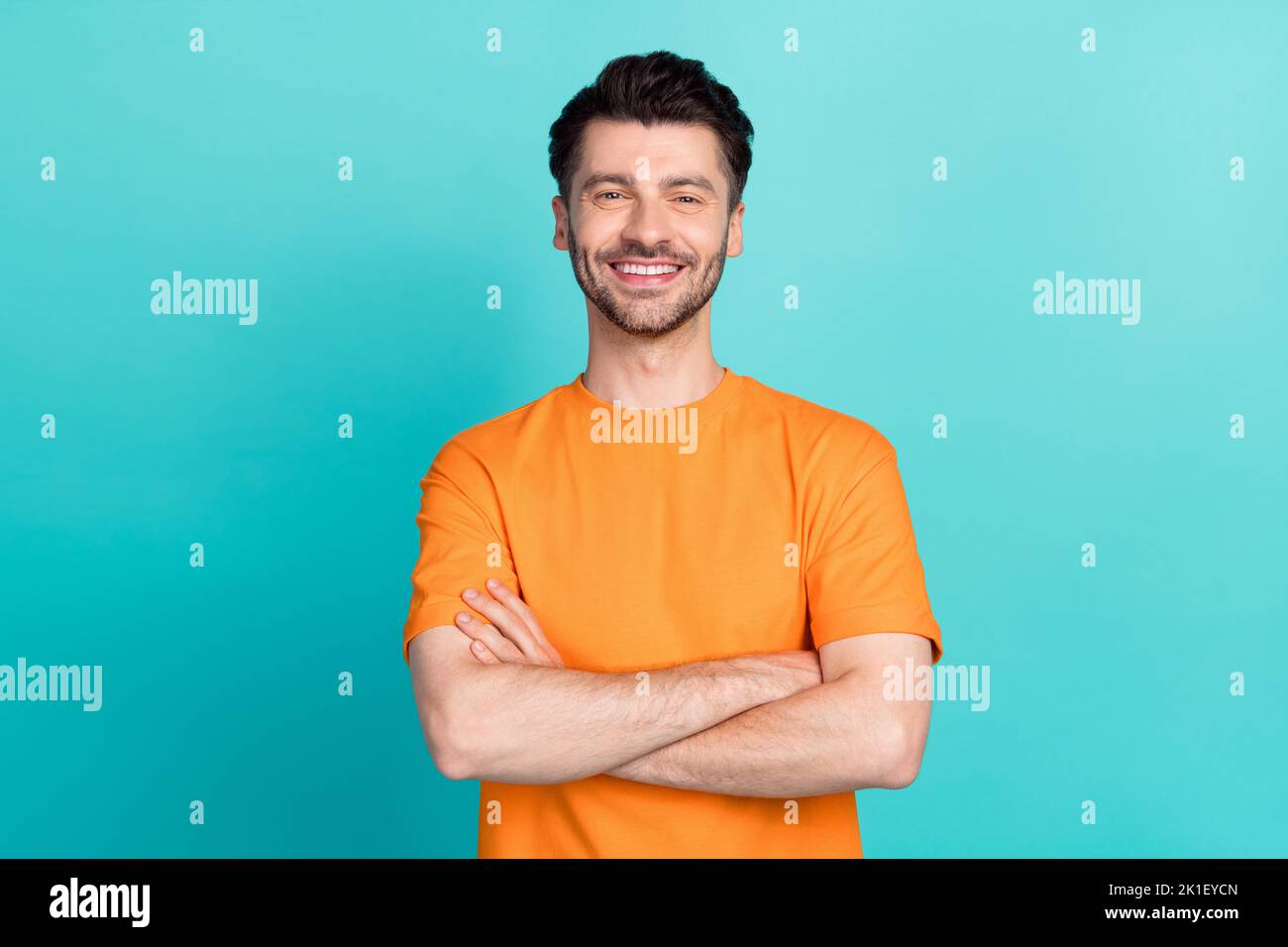 Portrait photo of young successful positive good mood man wear orange t ...