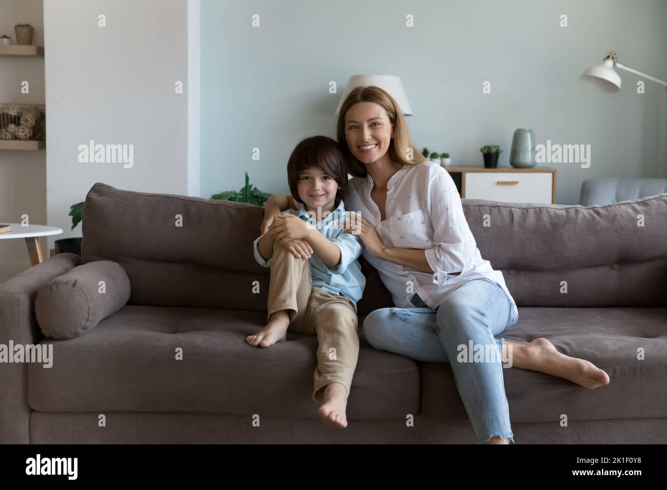Happy loving mom hugging cute preschool son, looking at camera Stock ...