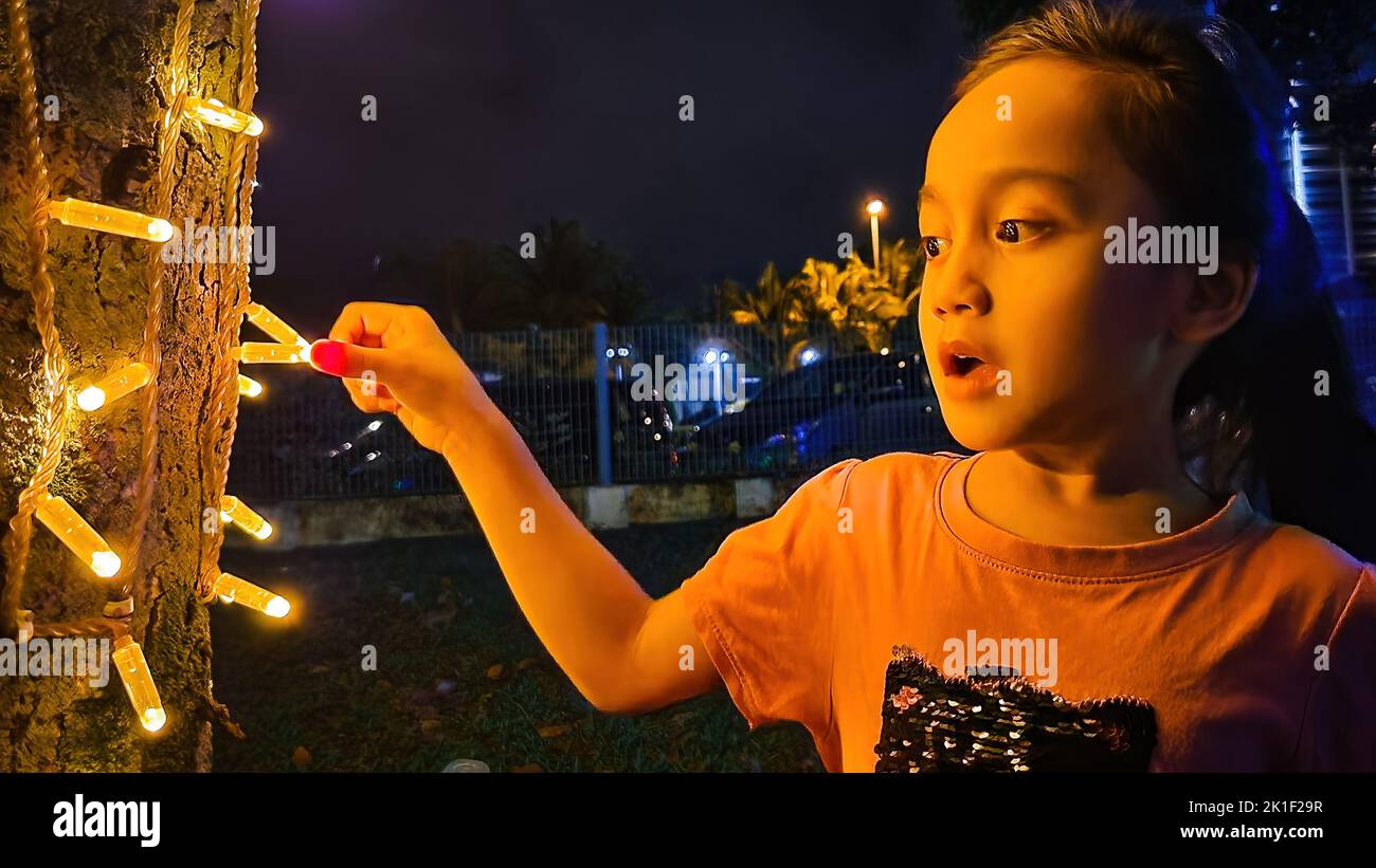 Neon portrait of a little girl with the LED lights. Lifestyle of young ...