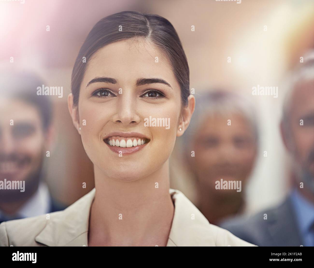 Shes set on success. Portrait of a young businesswoman standing in front of her colleagues Stock ...