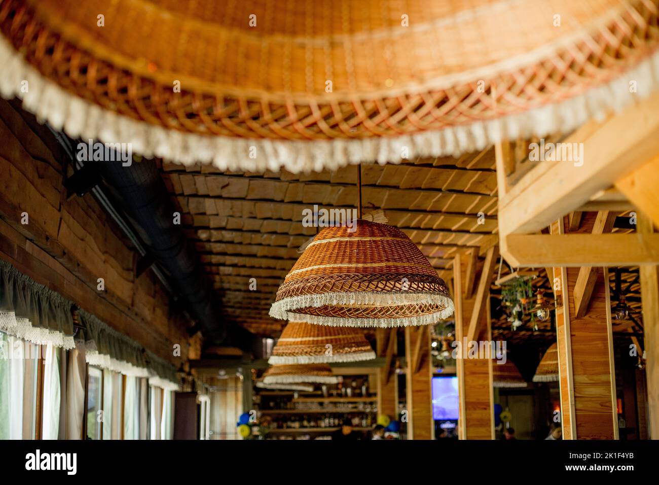 Wicker straw lamps, wooden roof. Trendy interior design of a hipster ...