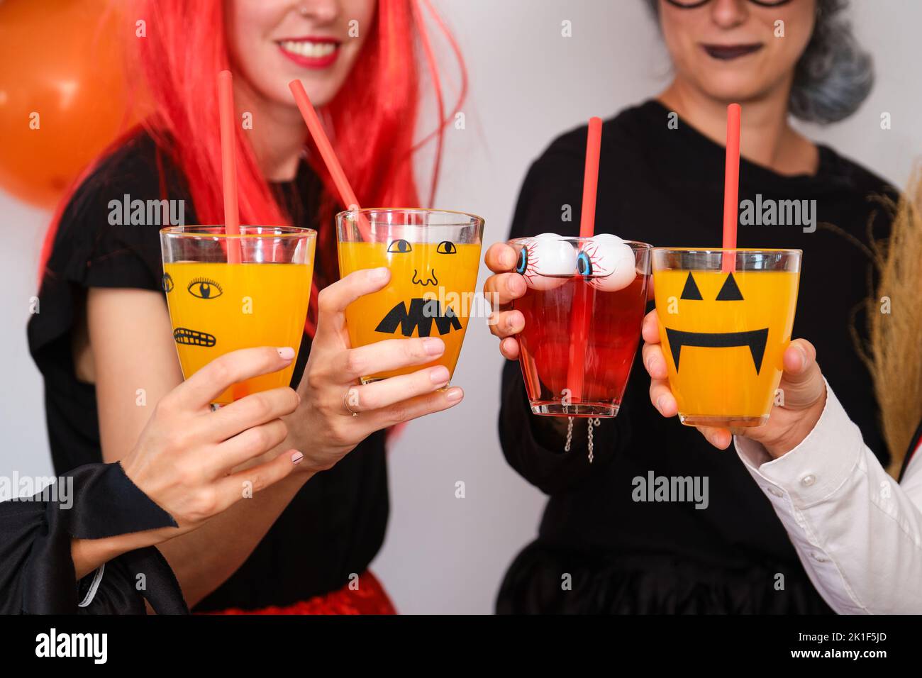 Four people doing a toast at a costume Halloween party Stock Photo - Alamy
