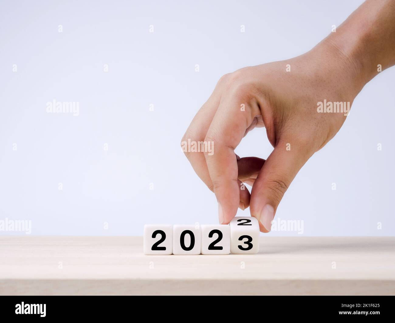The calendar year 2022 changed to 2023, success concept. White cube ...