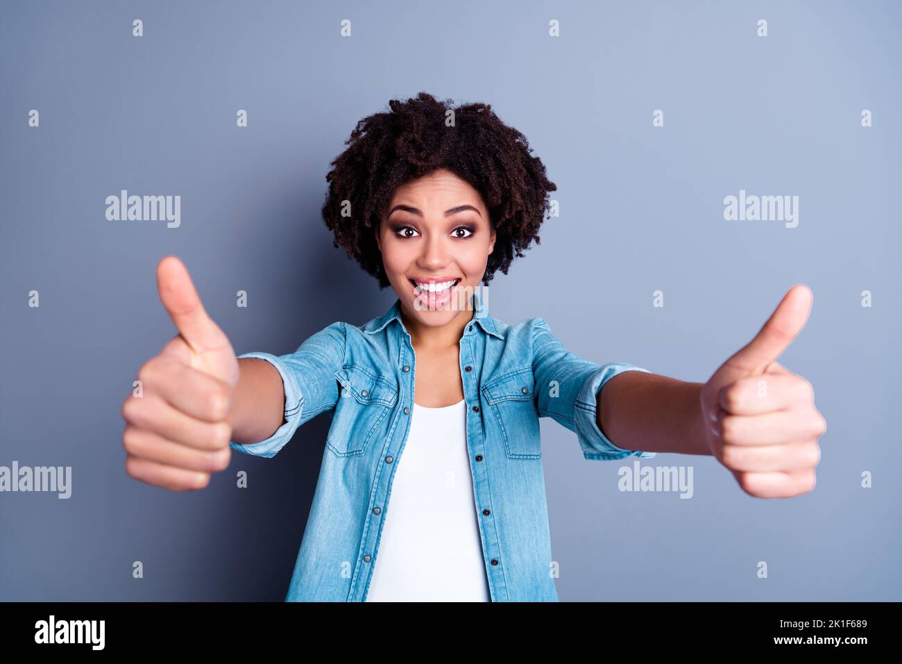Portrait of positive nice lady hands fingers demonstrate thumb up rate ...