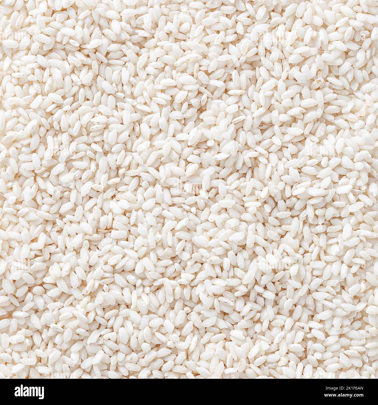 Uncooked arborio rice background Stock Photo - Alamy