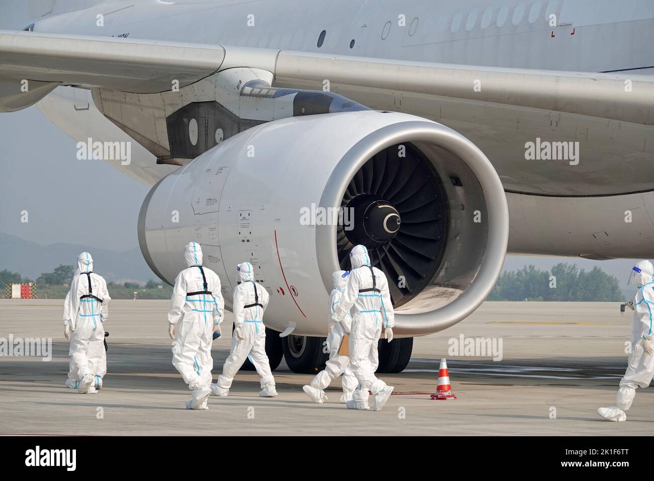 YANTAI, CHINA - SEPTEMBER 18, 2022 - Airport staff in protective suits ...