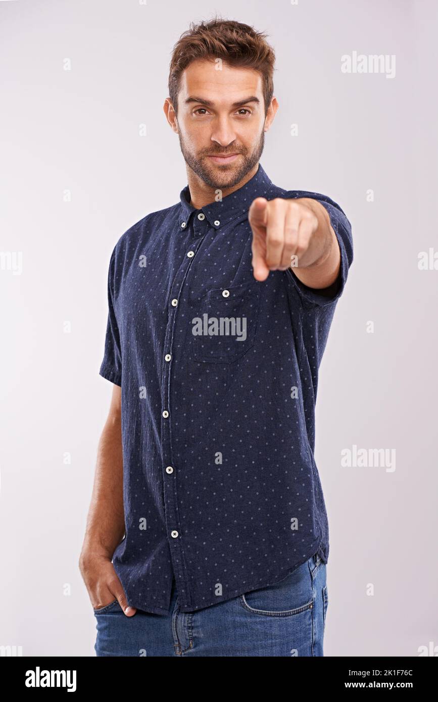 He knows what he wants. A handsome young casually dress man pointing ...
