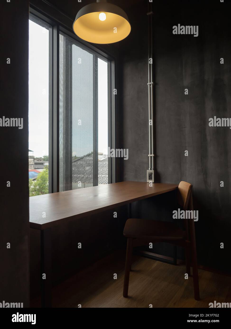 Vintage ceiling lamp with yellow warm light bulb hanging over the empty ...