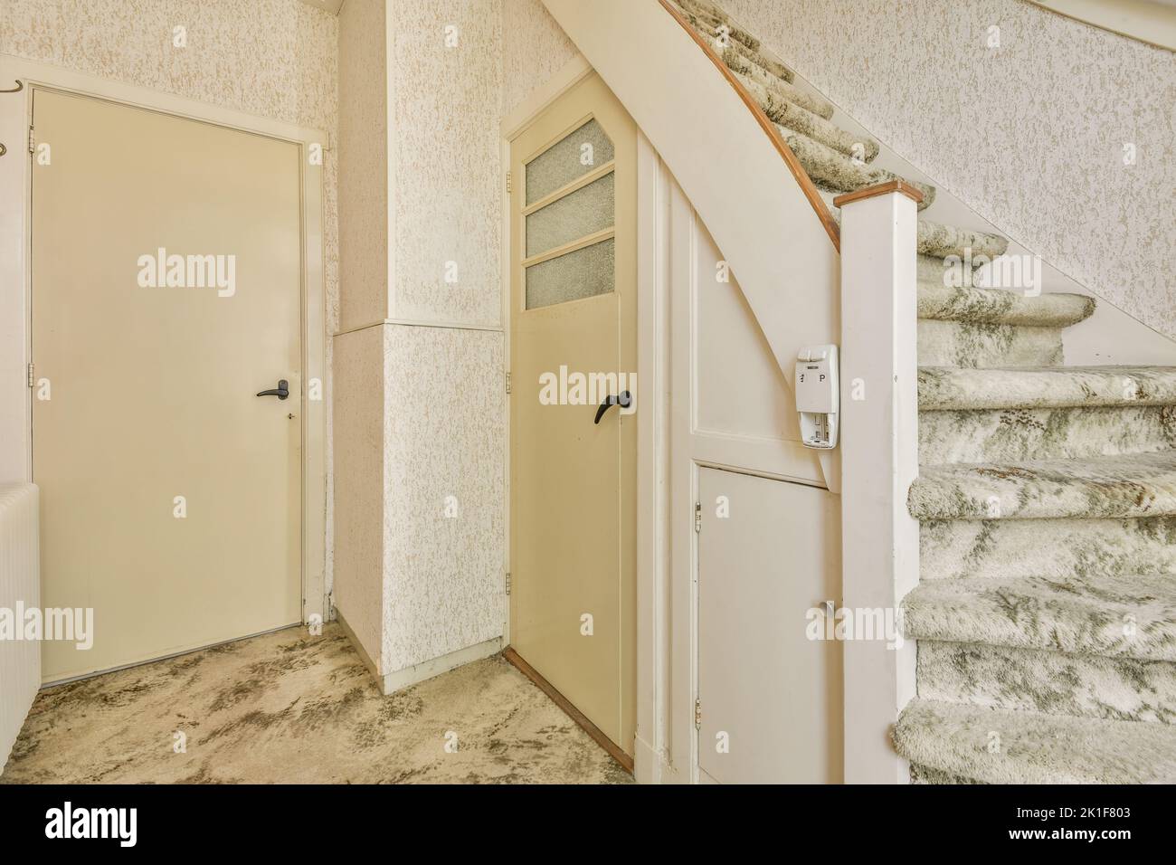 Light hallway with entrance door in two level apartment with minimalist ...