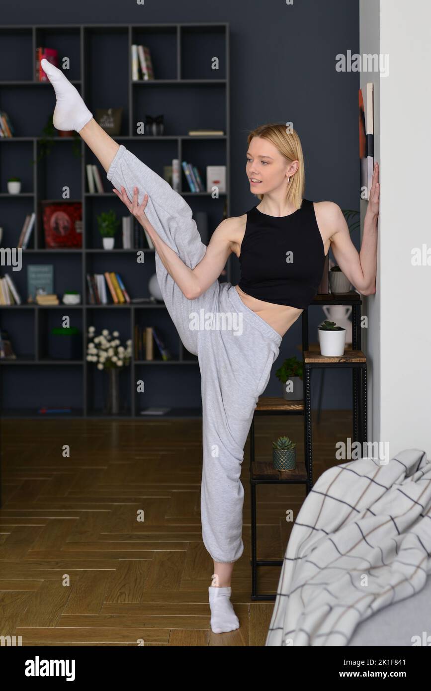 Woman practicing lifting her leg high Stock Photo - Alamy