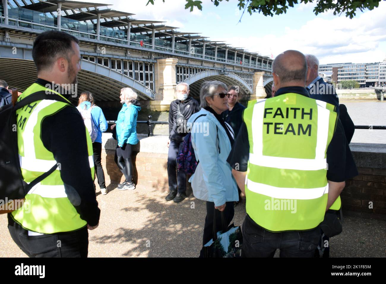 Faith Team supporting people queuing along River Thames in order to ...
