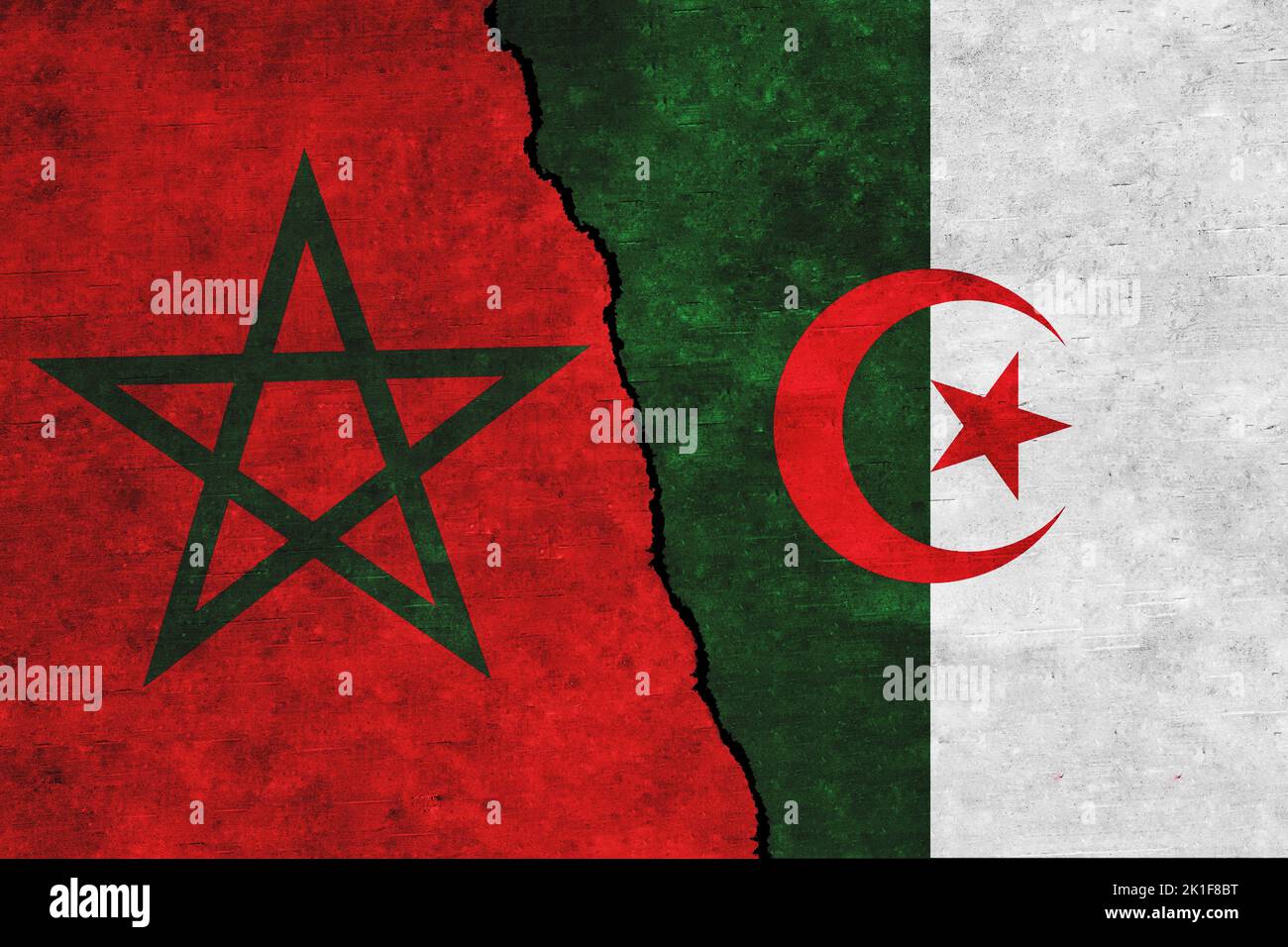 Morocco and Algeria painted flags on a wall with a crack. Diplomatic ...