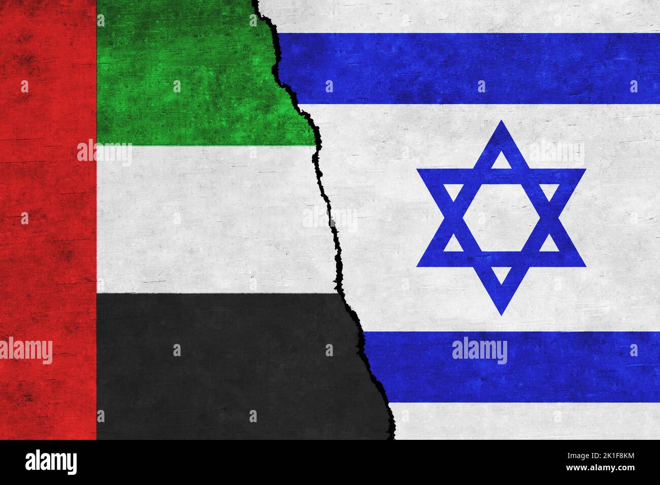 Israel and UAE painted flags on a wall with a crack. Israel and UAE ...