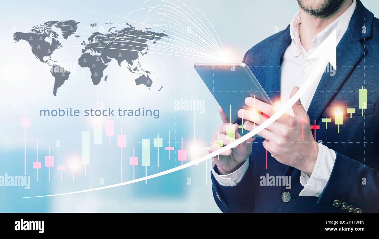 Businessman using the tablet with world map and financial graph on the ...