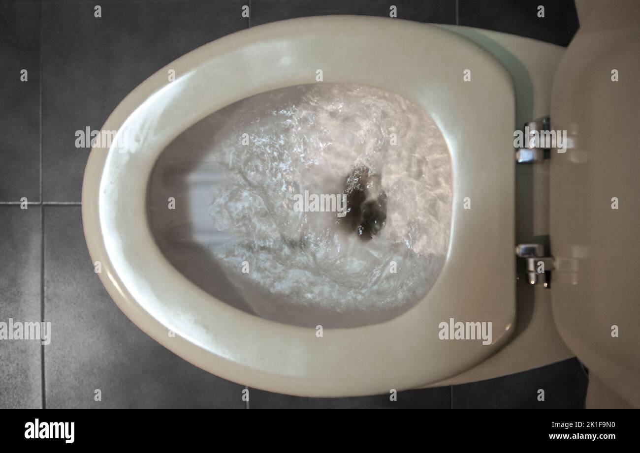 Old regular toilet flushing excessive use of water. Low-efficiency ...