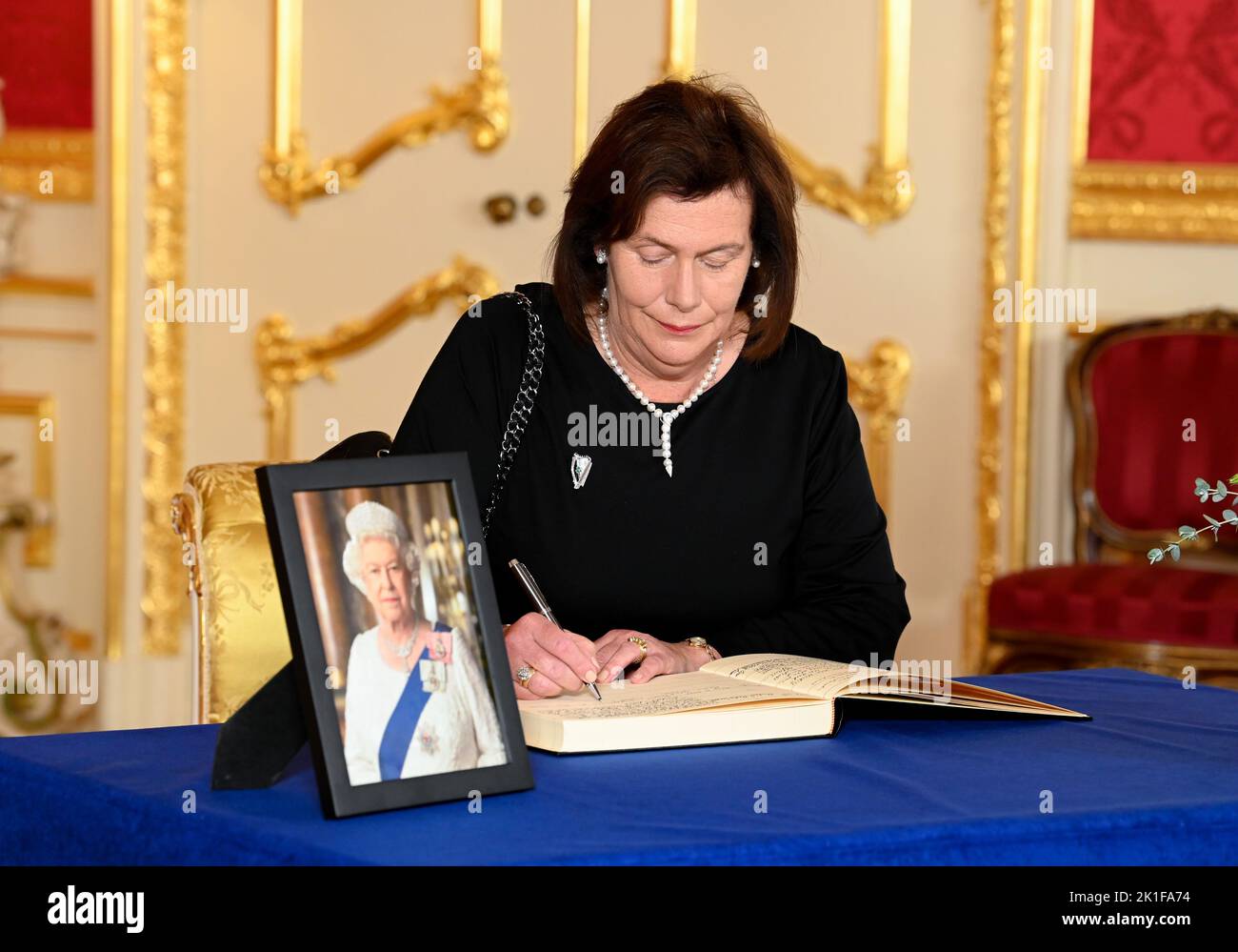 Mary O'Shea, the wife of Ireland's Taoiseach Micheal Martin signs a ...