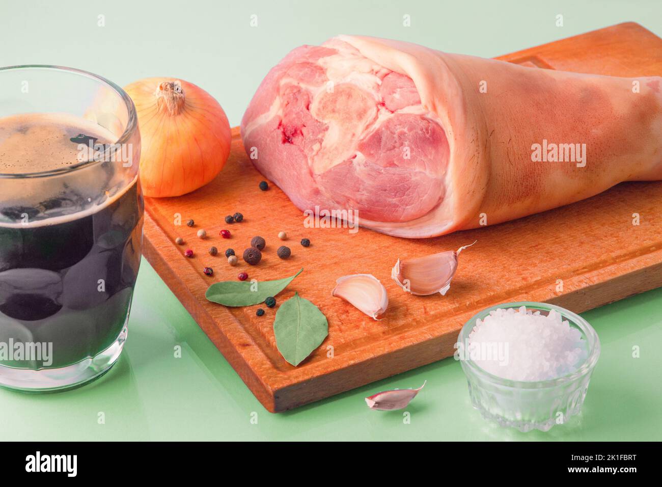 Close-up of Raw Pork knuckle, dark beer and other ingredients for ...