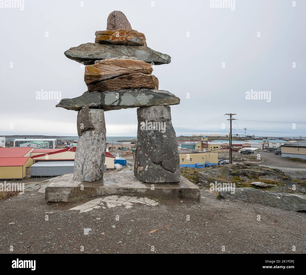 Inukshuk (Inuksuk) on hilltop above the town Rankin Inlet on the Hudson ...