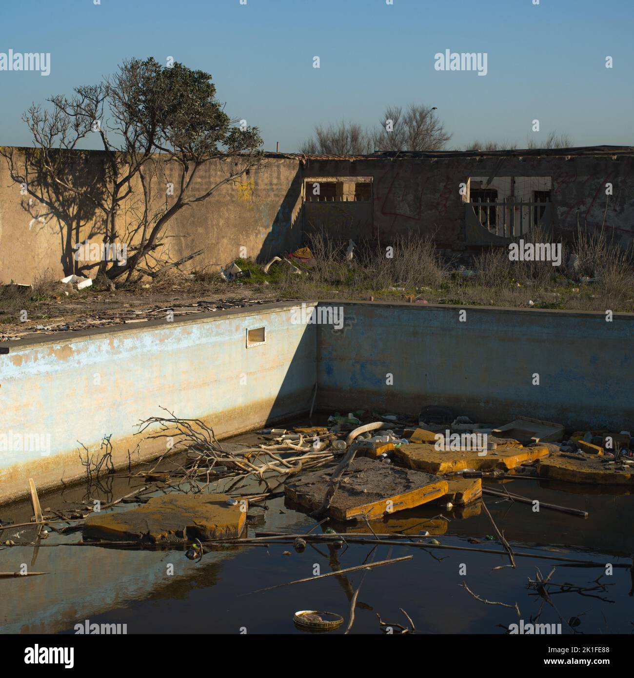 An abandoned dirty pool with ruins inside a house Stock Photo - Alamy