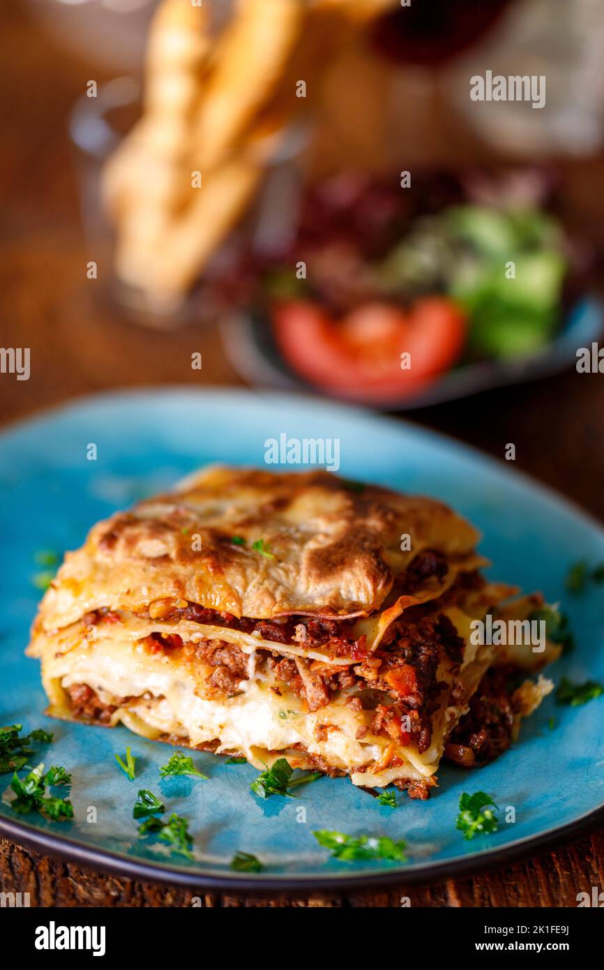 fresh lasagna on a blue plate Stock Photo - Alamy