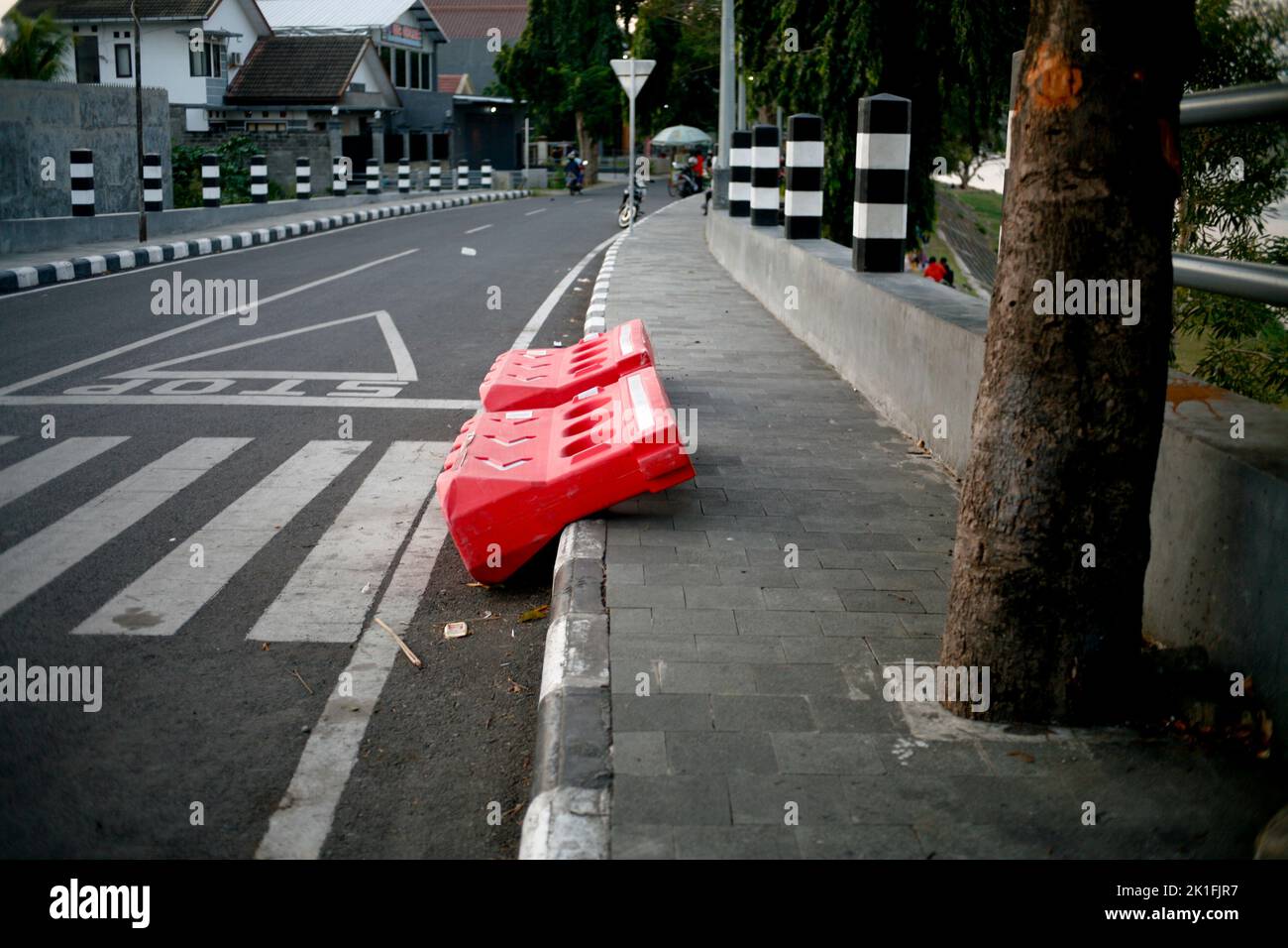 Orange plastic construction barriers on the side of street Stock Photo ...