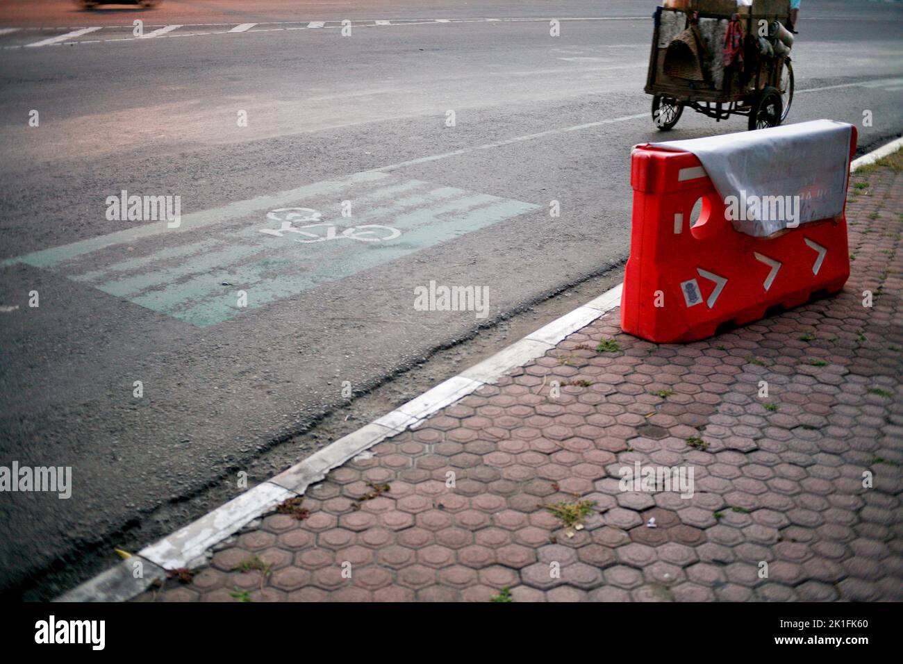 Orange plastic construction barriers on a street with motion motorcycle ...