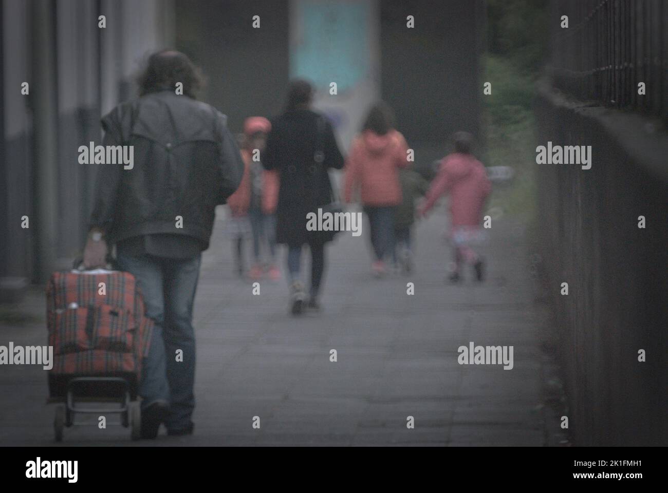 A long-haired poor man with a shopping cart in Essen, Germany Stock ...