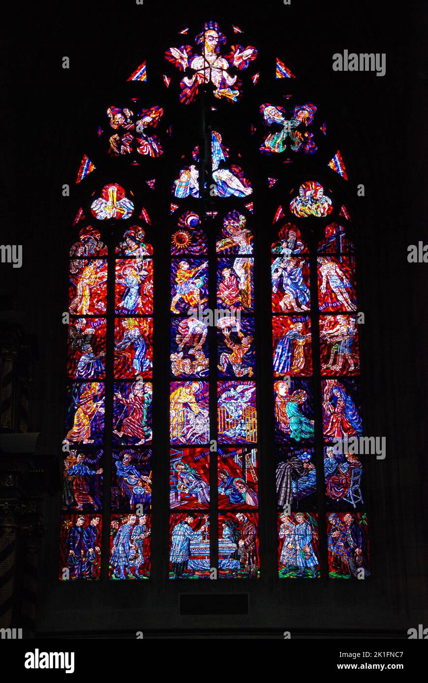 A vertical shot of the a stained glass window in St Vitus Cathedral in ...