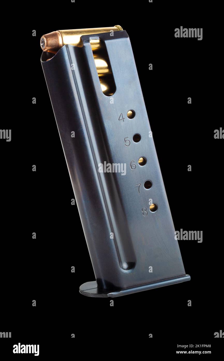 Hollow points loaded into a semi-automatic handgun magazine on a black ...