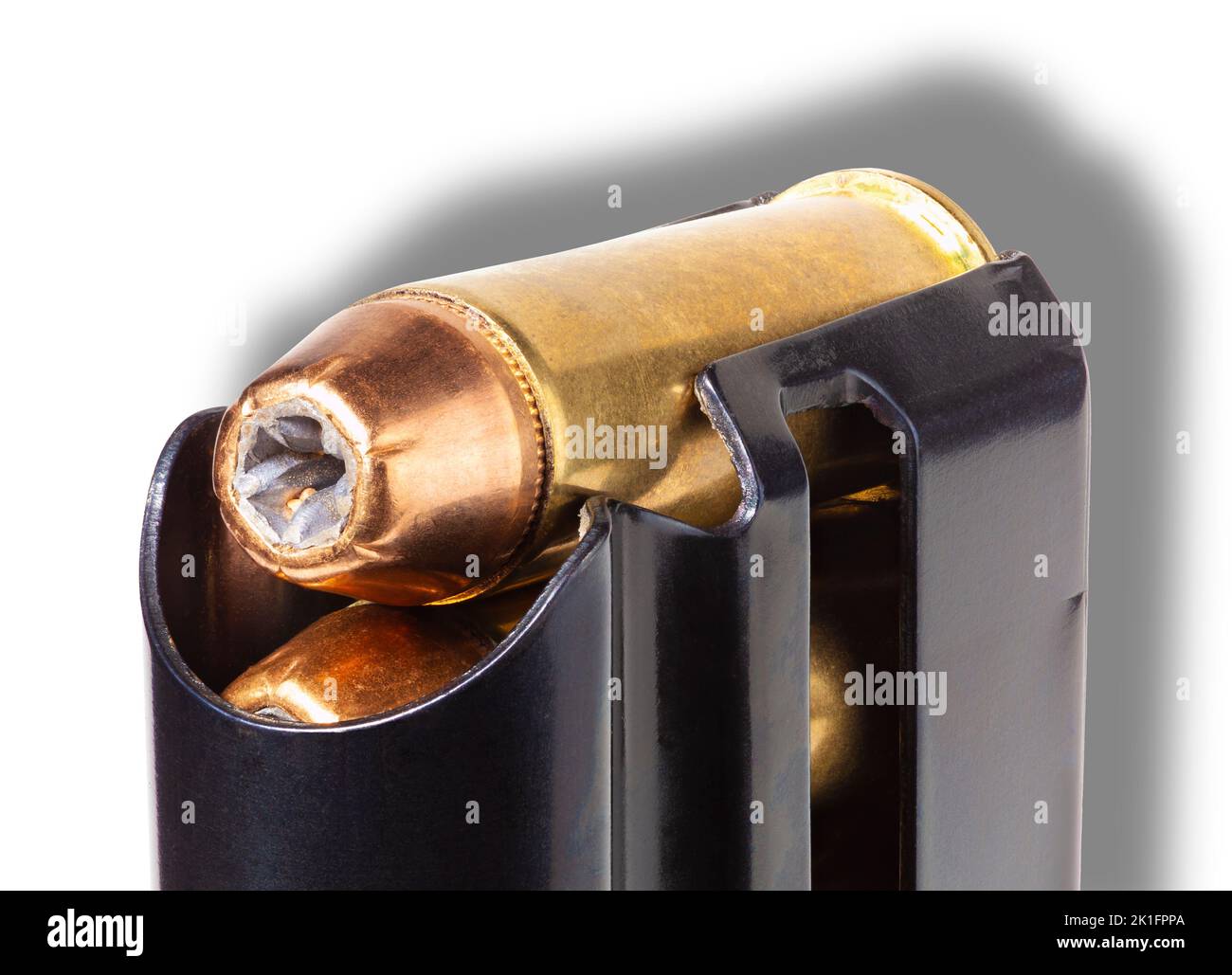 Hollow points and pistol magazine on white with drop shadow behind ...