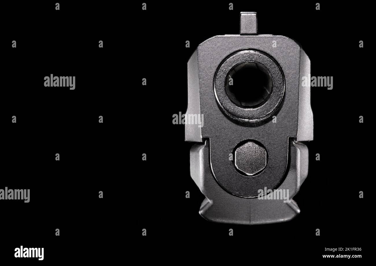 Semi auto handgun from the front on a black background with copy space ...