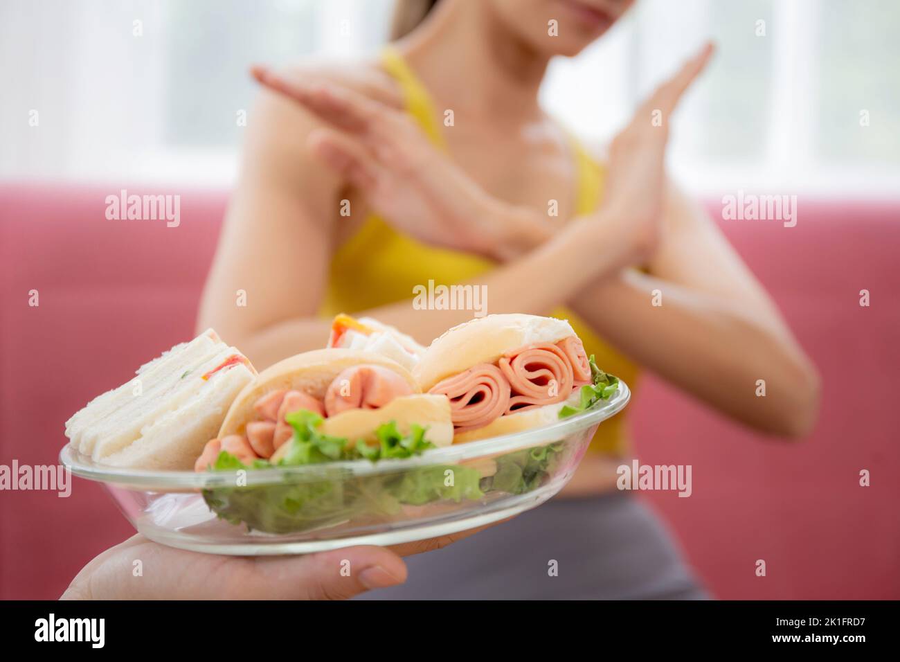 Hands serving food and young caucasian woman making sign say no food ...