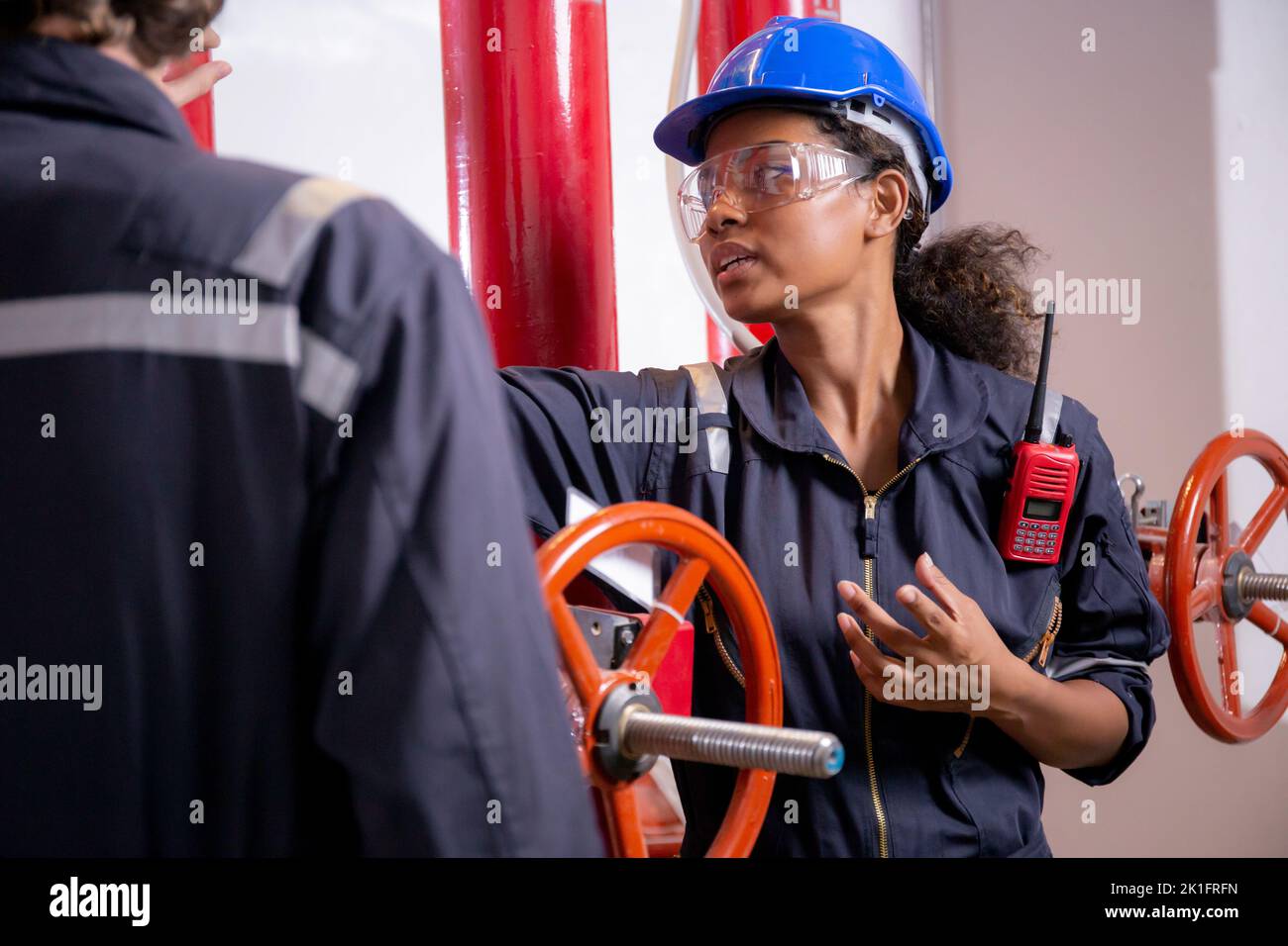 Young woman and man engineer check and examining pipeline and ...