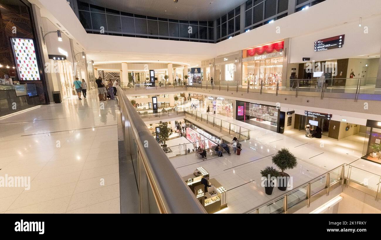 Inside a Shopping Mall with bright lights of the stores in Dubai, UAE ...