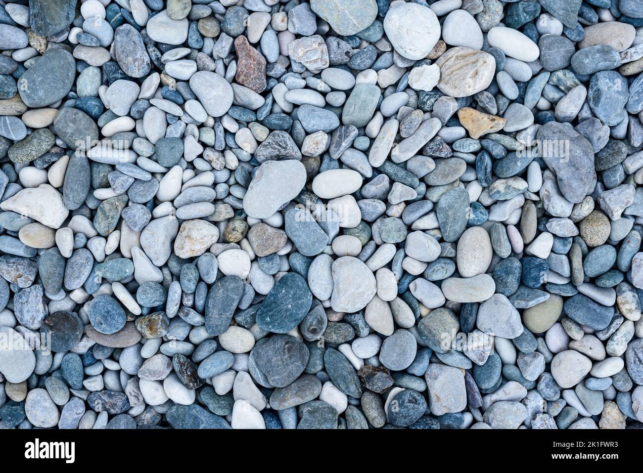 Small grey pebbles cover sea beach for visitors to relax Stock Photo ...