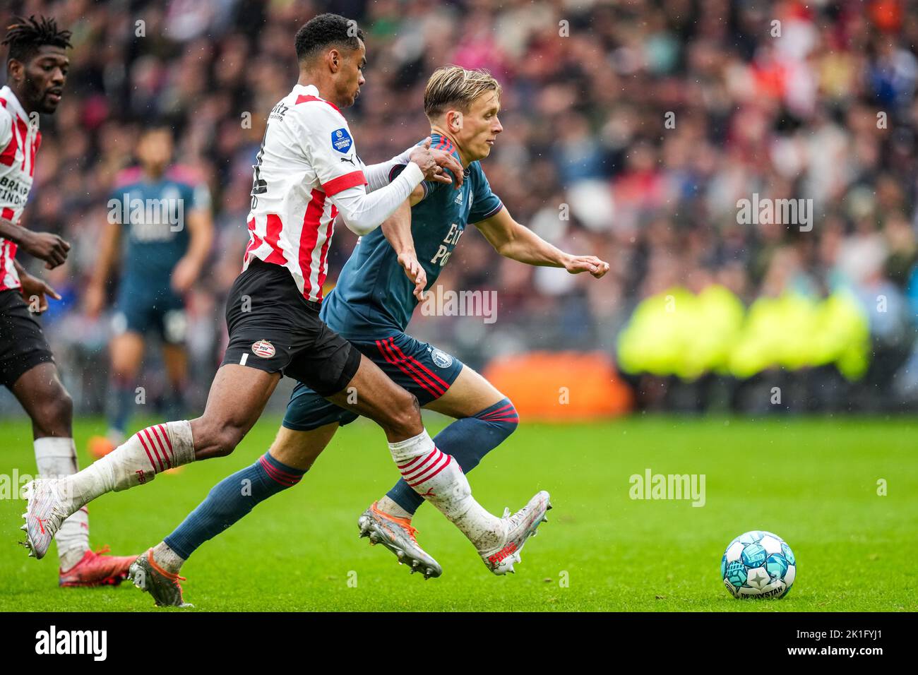 Eindhoven - Cody Gakpo of PSV Eindhoven, Marcus Holmgren Pedersen of Feyenoord during the match ...