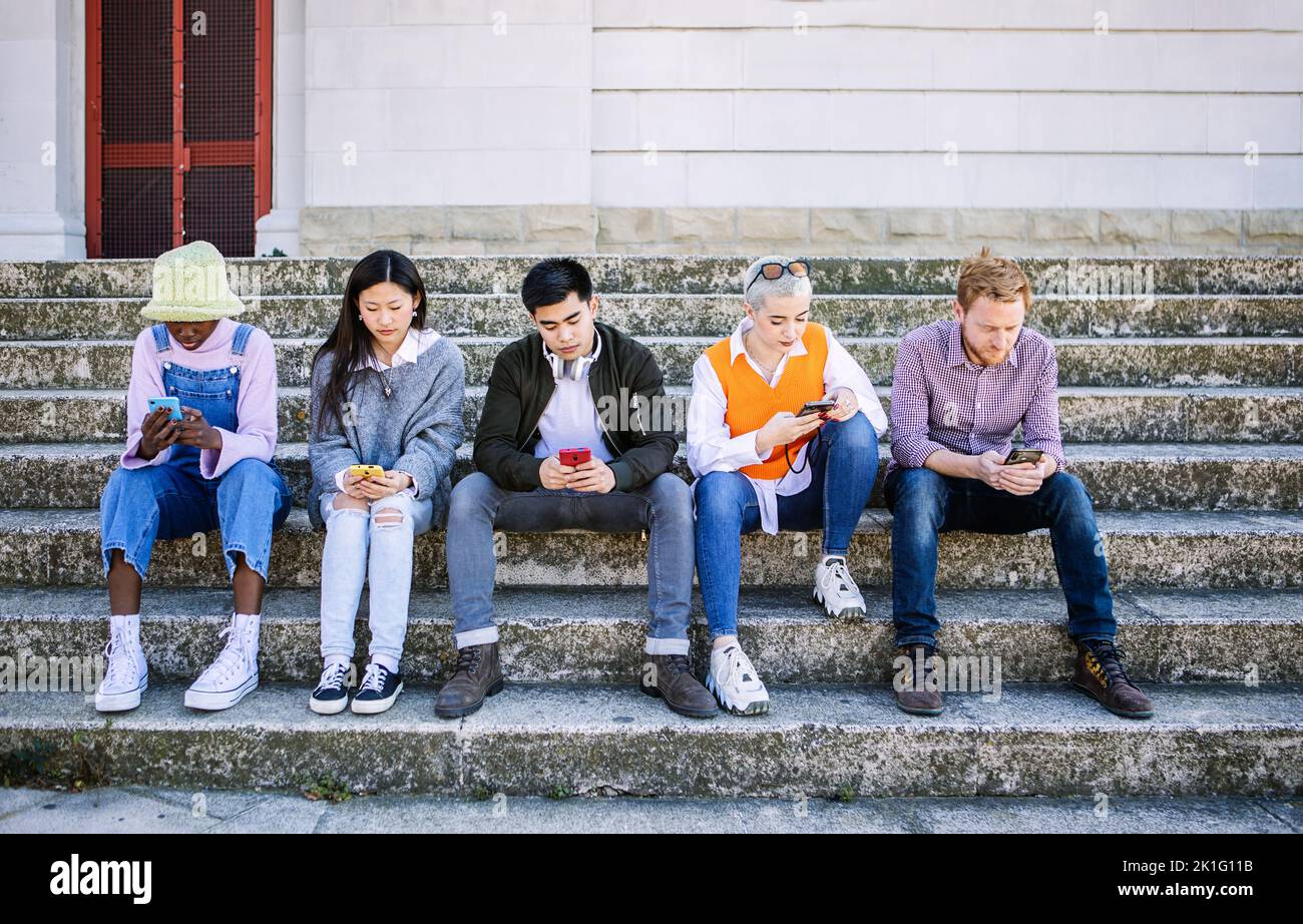 Friends group of millennial people using mobile smart phone together Stock Photo - Alamy