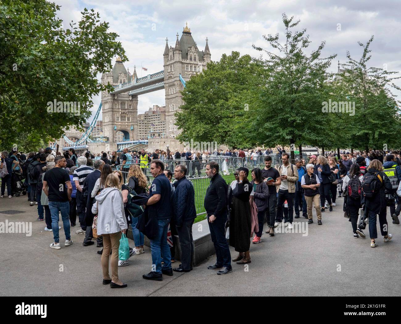 Members of the public queue back to tower bridge to pay their respects ...