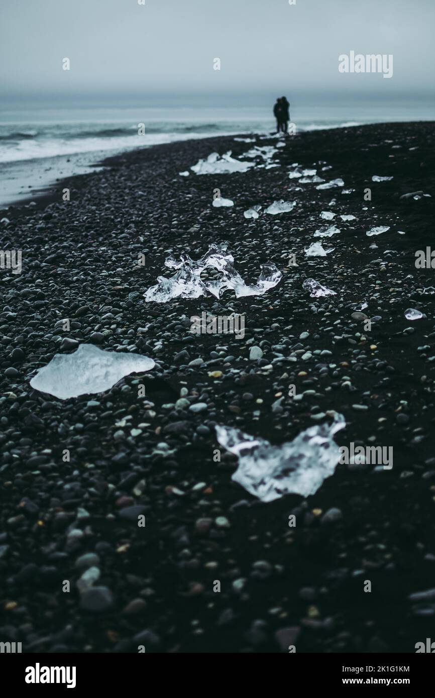 Icelandic coast of Atlantic Ocean covered with pebbles and huge pieces ...
