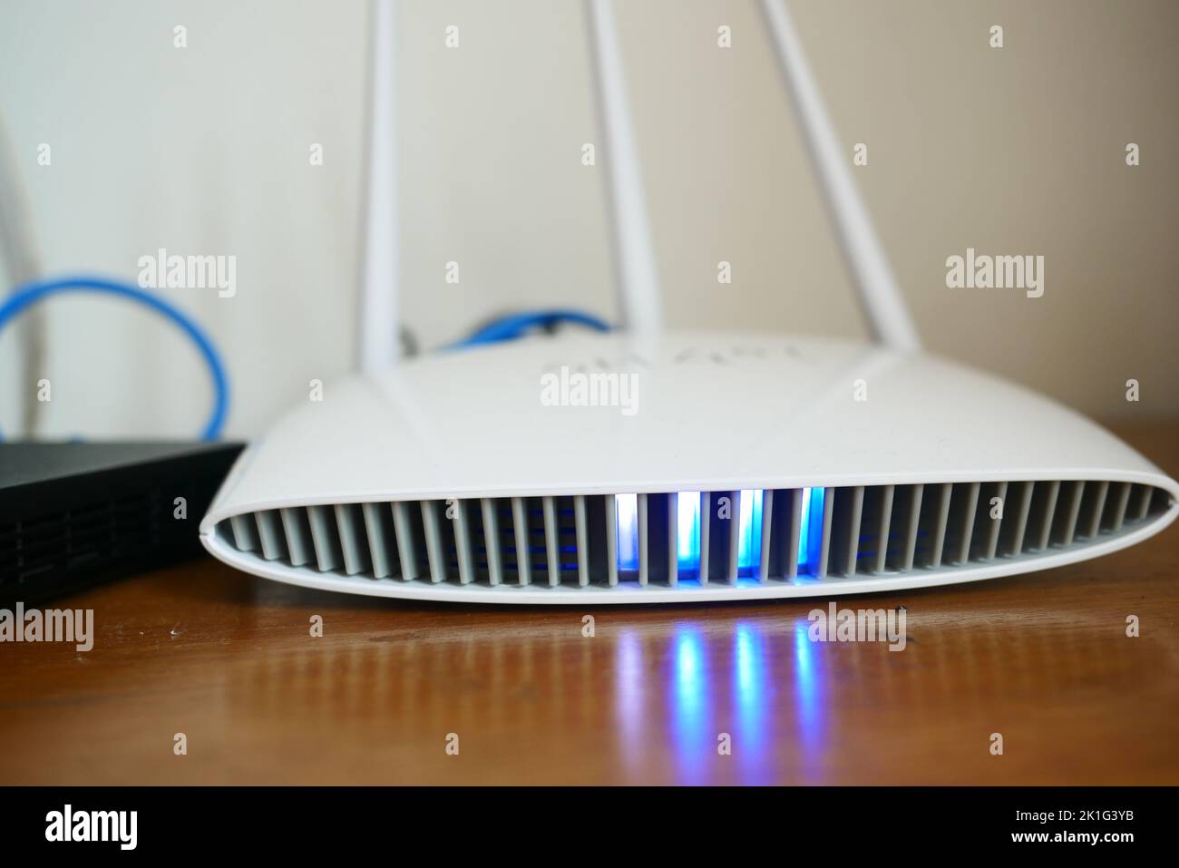 Wi-Fi router with cables on table Stock Photo - Alamy