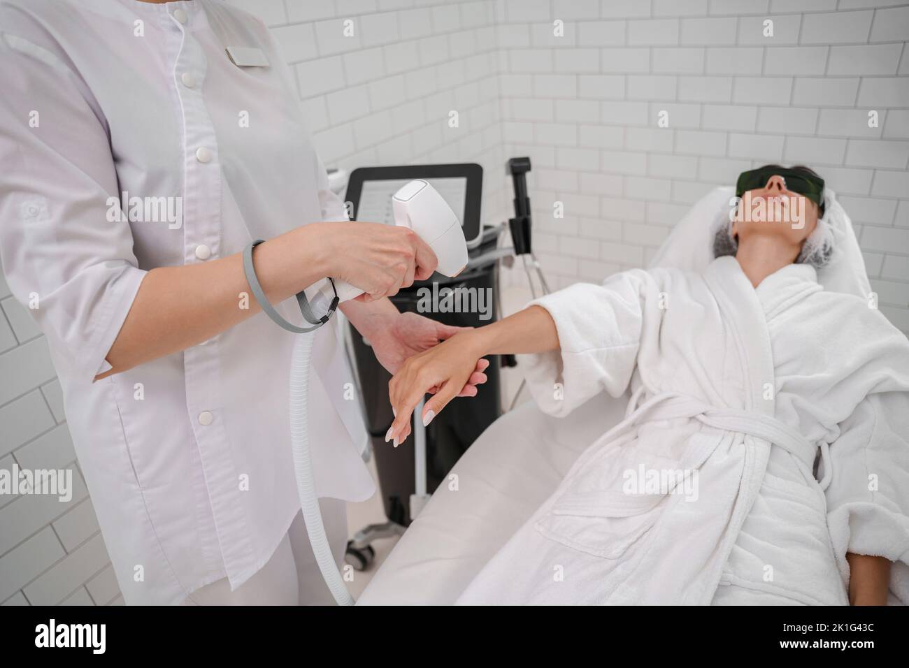 Woman getting hair removing procedure on hands. Laser epilation and ...