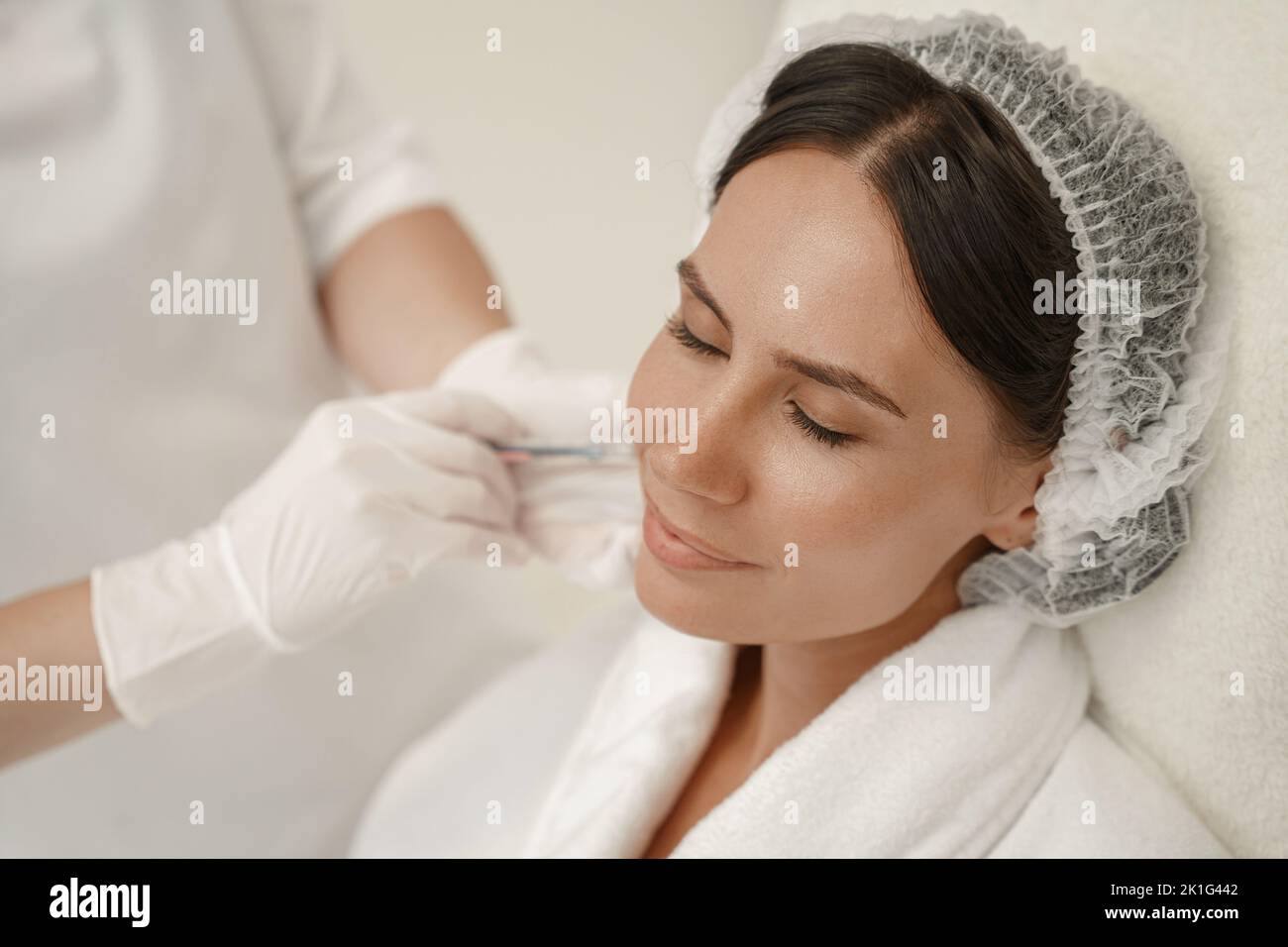 Cosmetologist makes rejuvenating anti wrinkle injections on face of ...