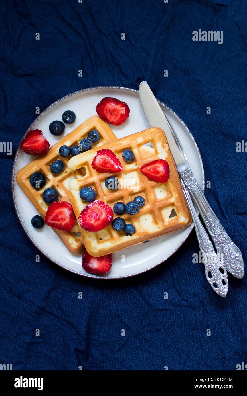 Traditional belgian waffles with fresh berries blueberry and strawberry ...