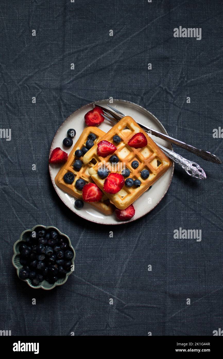 Traditional belgian waffles with fresh berries blueberry and strawberry ...