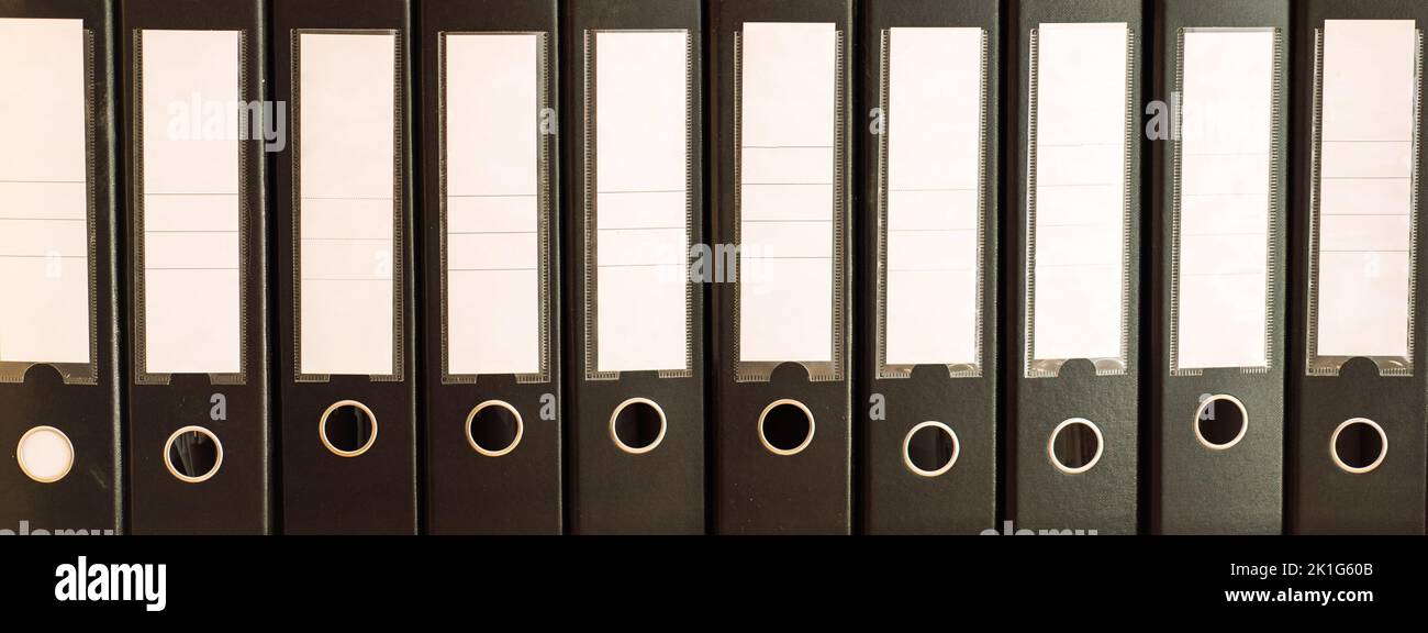 Black office folders standing on cabinet shelves Stock Photo - Alamy