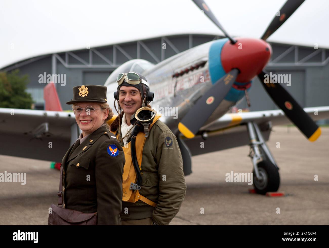 Reenactment actorsposing with the P-51D Mustang 'Tall In The Saddle' (G ...