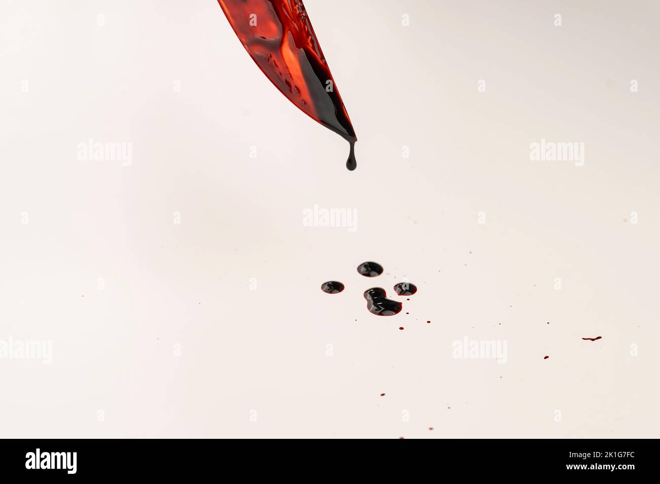 Close-up of a sharp knife covered in blood on a white background Stock ...