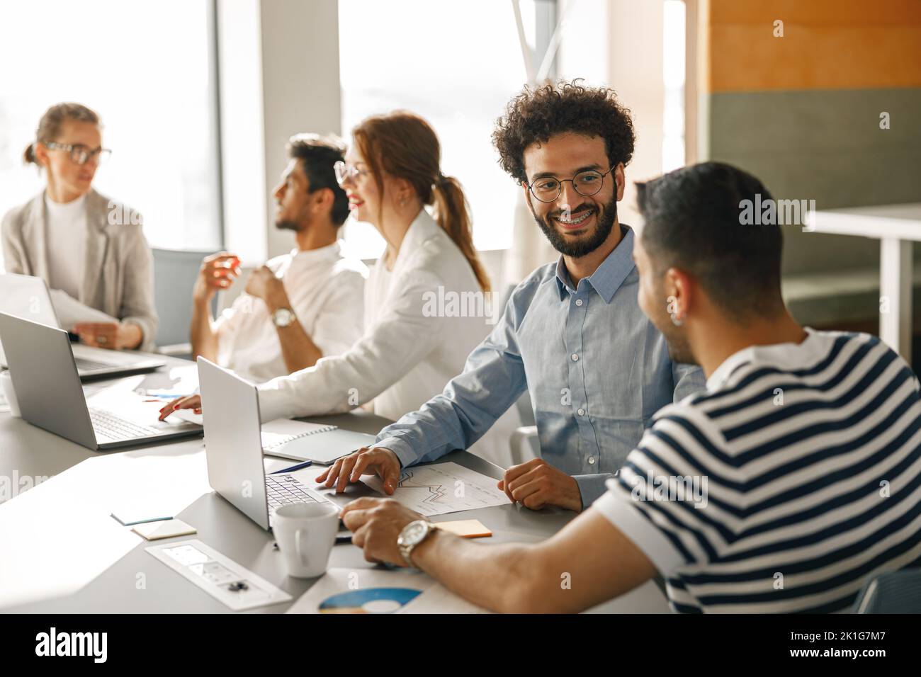 Busy coworkers cooperating and working together at office meeting ...