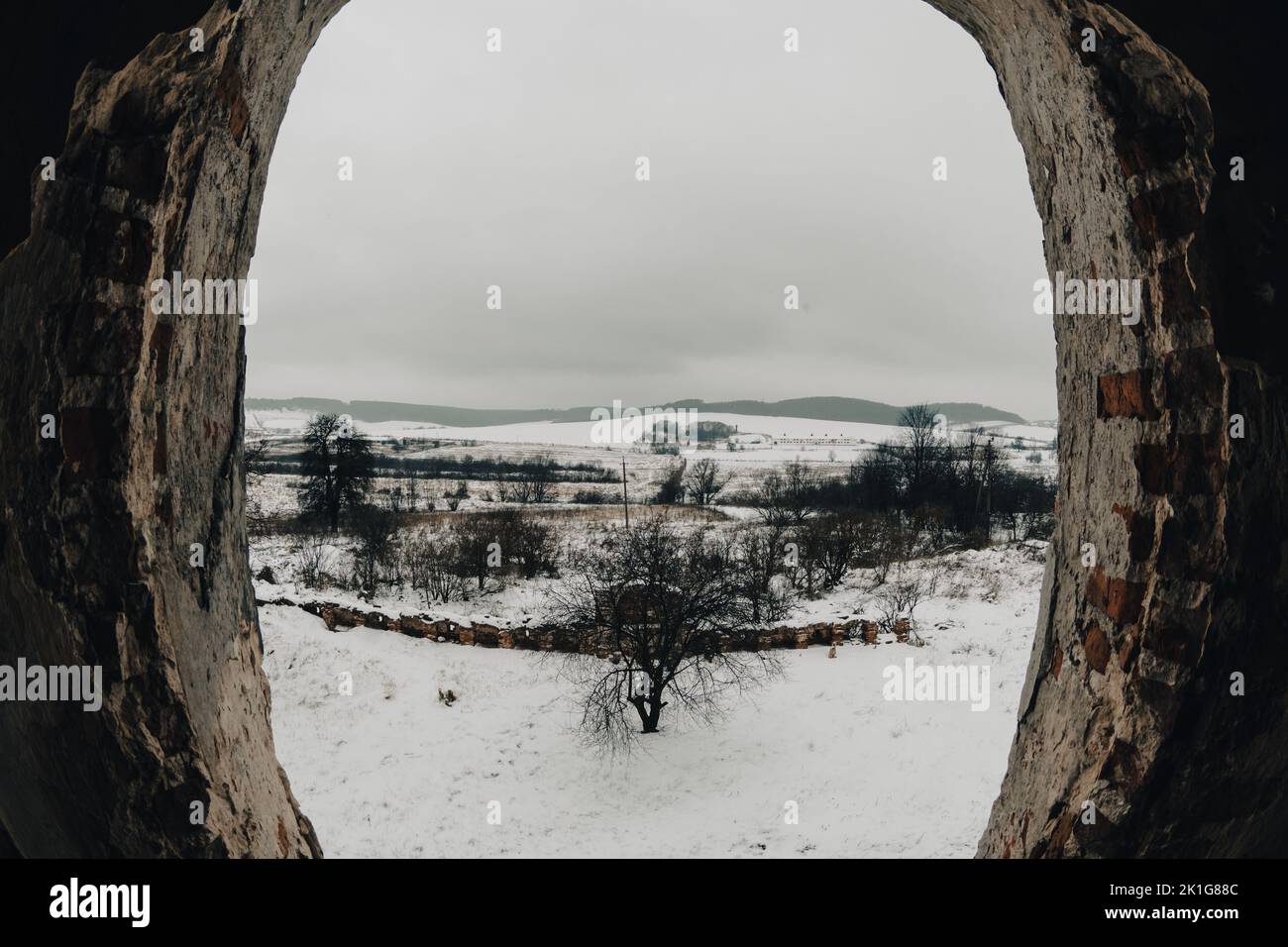 Bleak cold snowy fields in Ukraine. View from abandoned cathedral Stock ...