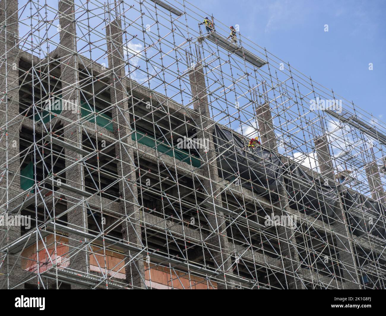 Construction Workers On Scaffolding In The Construction Of A Large New